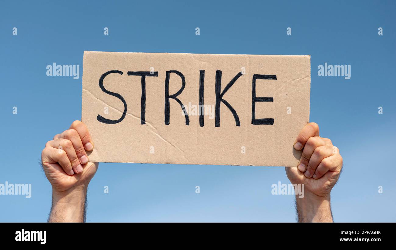 Protester holding board with strike Stock Photo - Alamy Protester holding board with strike Stock Photo - Alamy