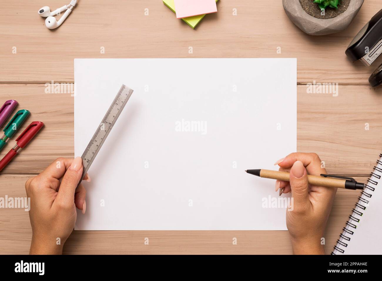 From hands holding ruler pen blank paper sheet Stock Photo - Alamy