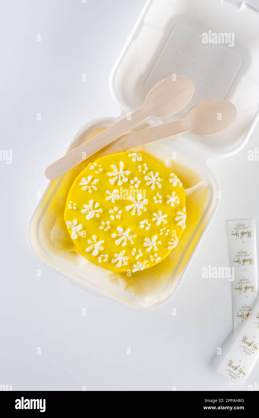 Trendy bento cake yellow color with cute decor on light background ...
