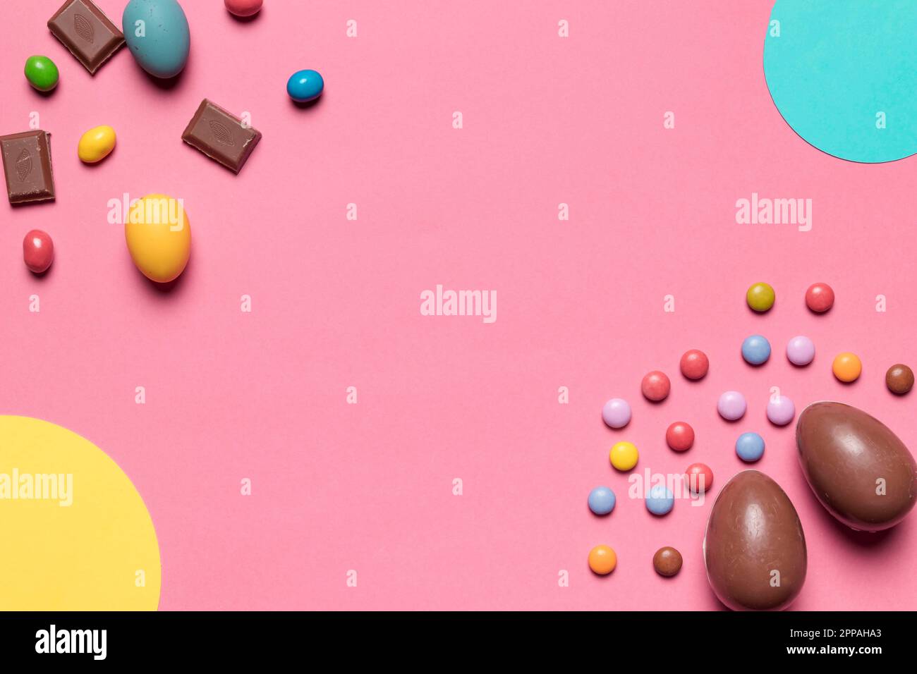 Chocolate easter eggs gem candies with copy space writing text pink ...