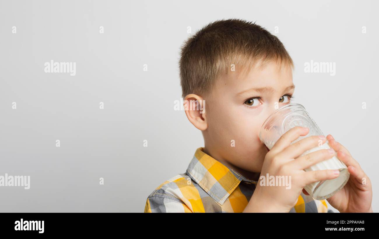 Boy drinking milk with glass Stock Photo - Alamy