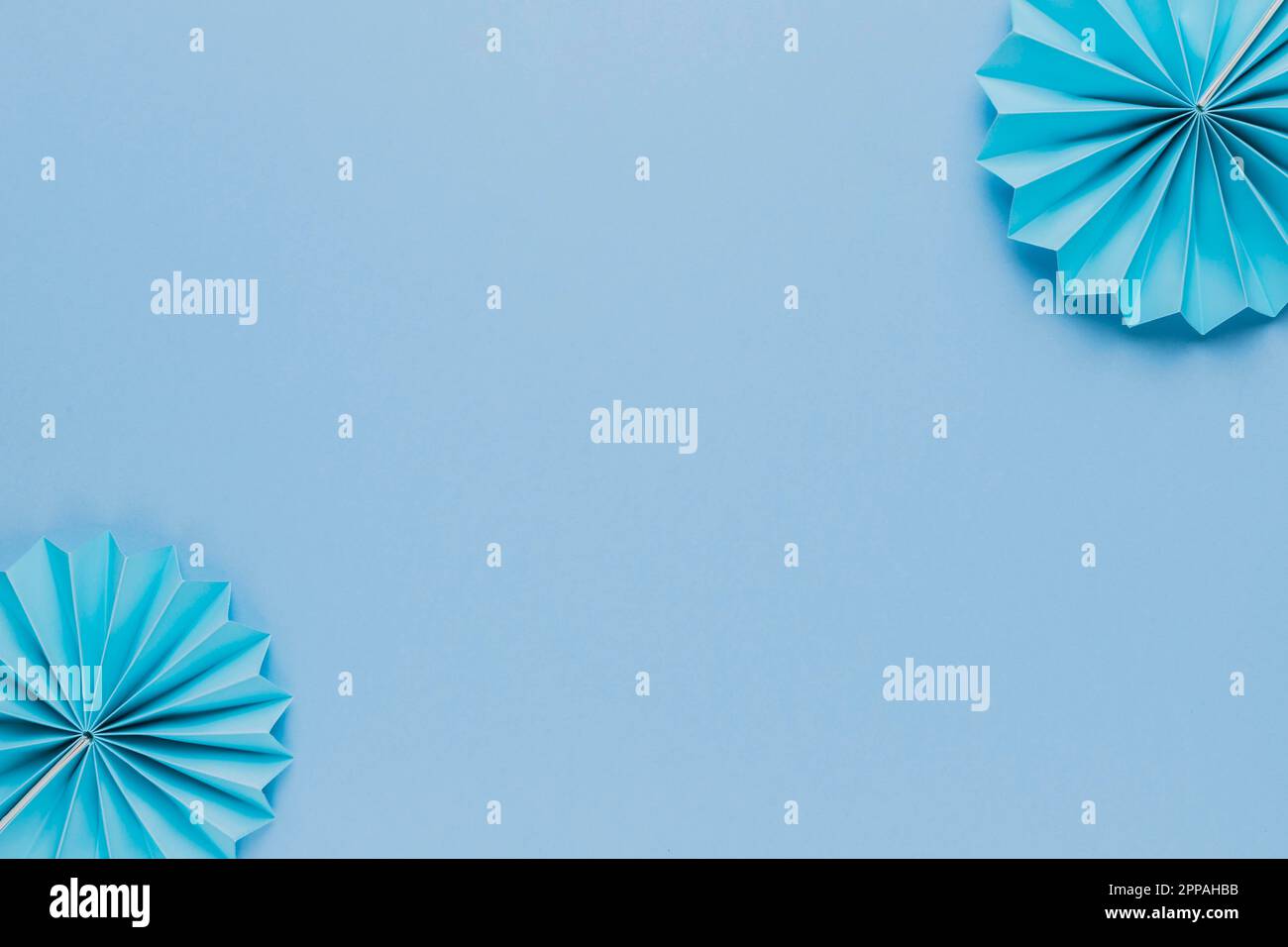 Blue origami paper fan corner blue backdrop Stock Photo - Alamy