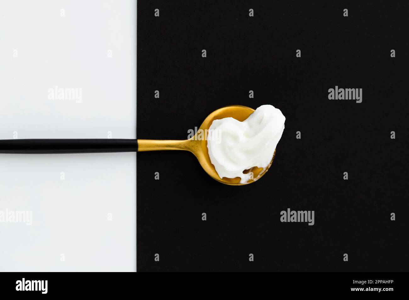 Whipped cream golden spoon Stock Photo - Alamy