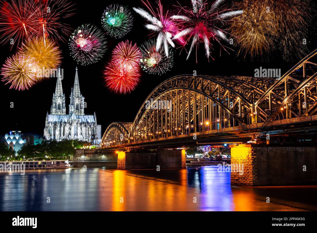 Night with fireworks in Cologne at the river Rhine with the illuminated ...