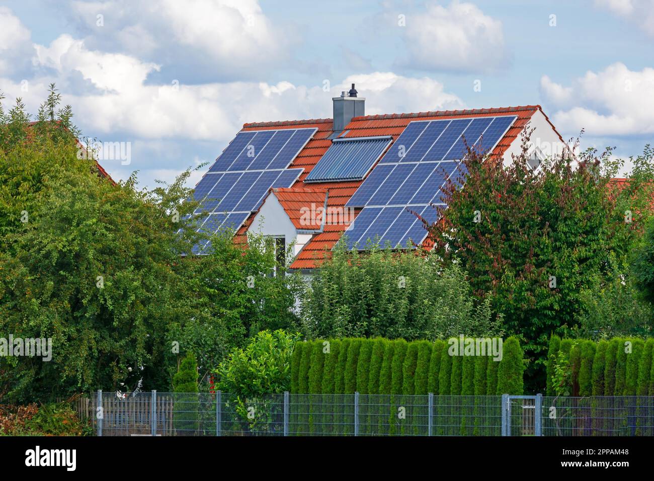 Modern house with photovoltaic solar cells on the roof and a thermal ...