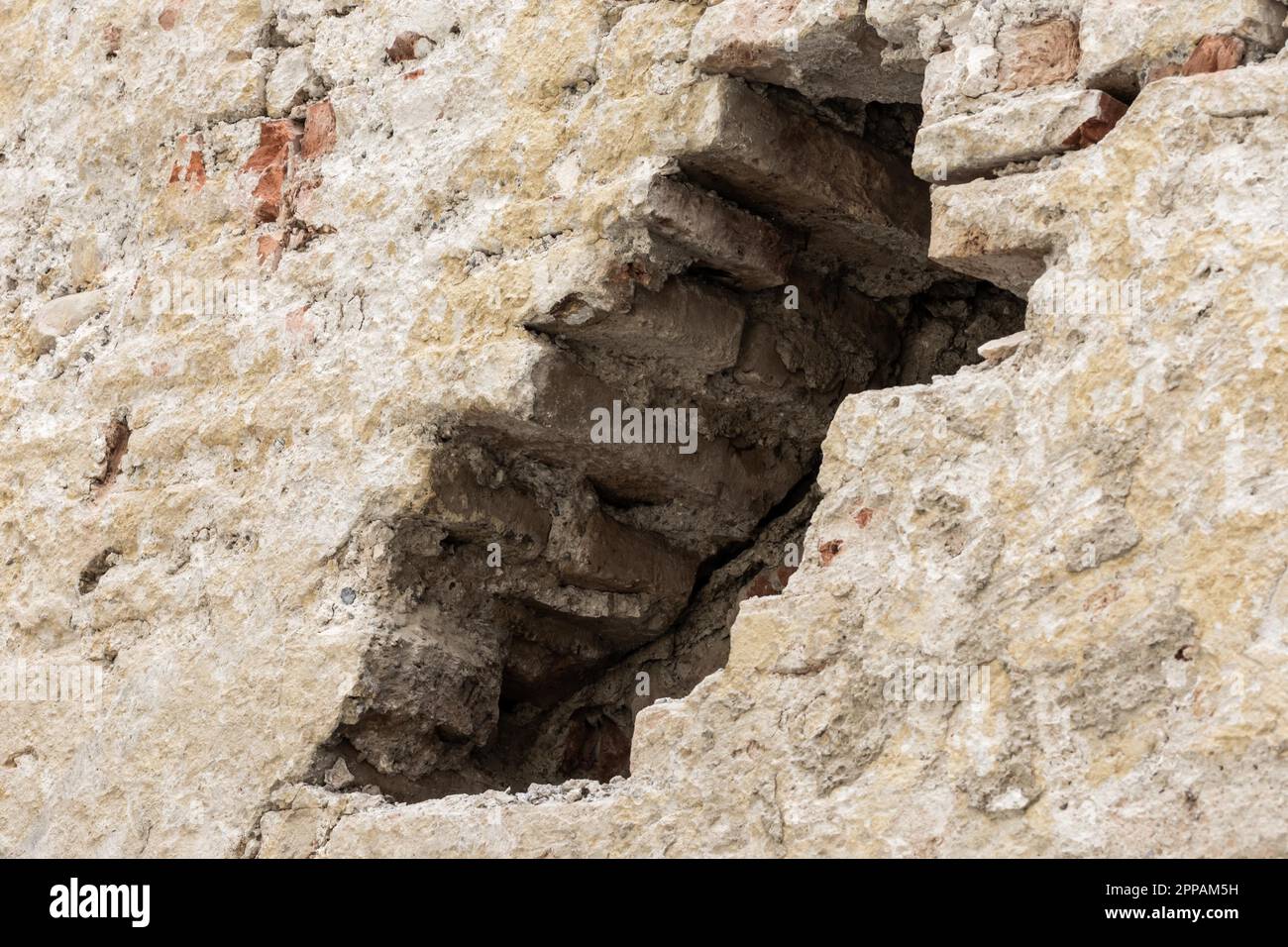 Hole in an old stone wall of a ruin Stock Photo - Alamy