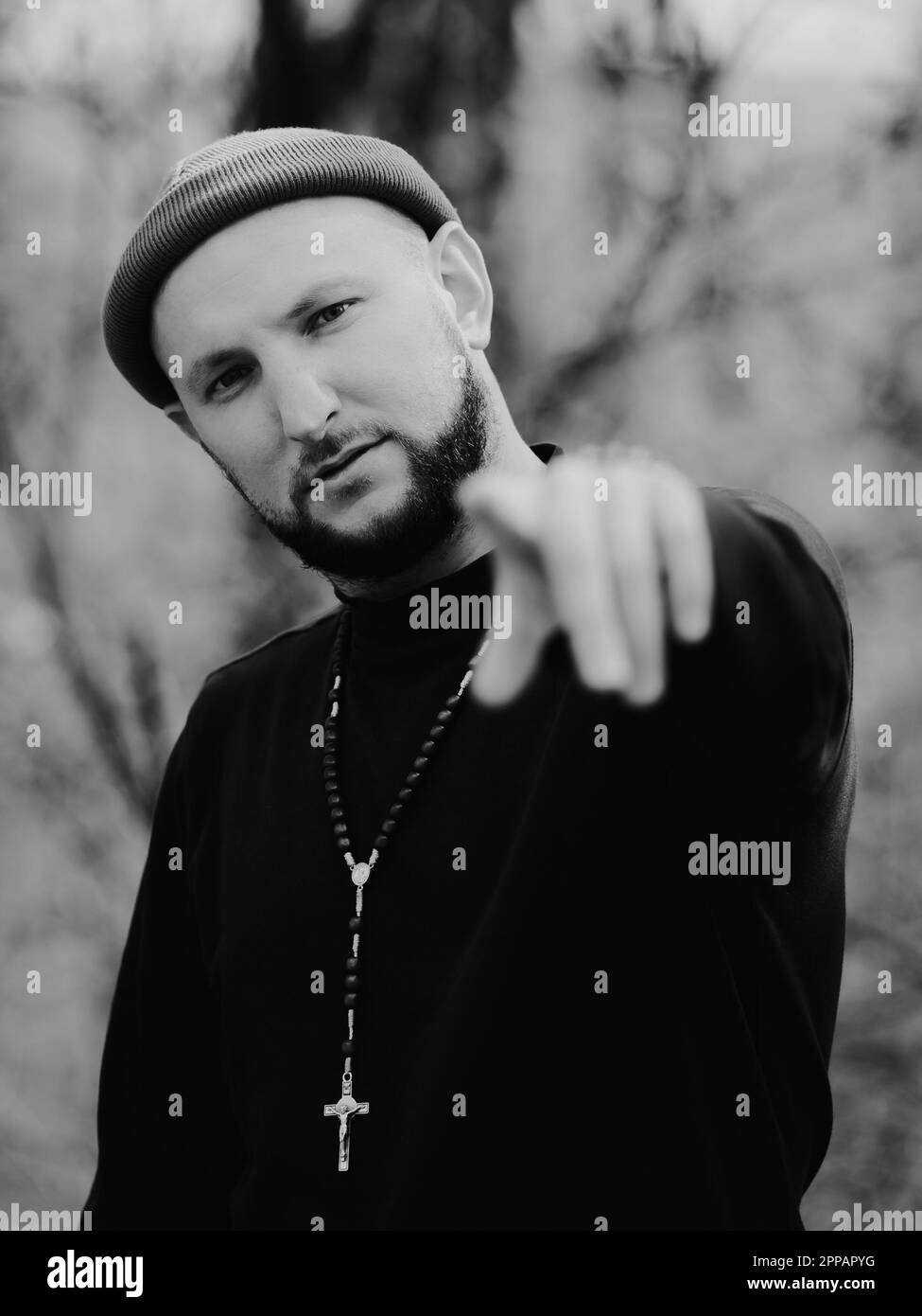 A serious man with a cross around his neck Stock Photo - Alamy