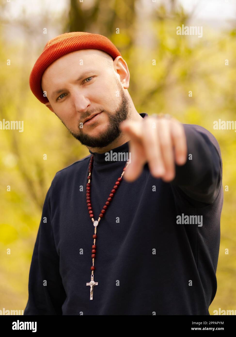 A serious man with a cross around his neck looking into your eyes Stock ...