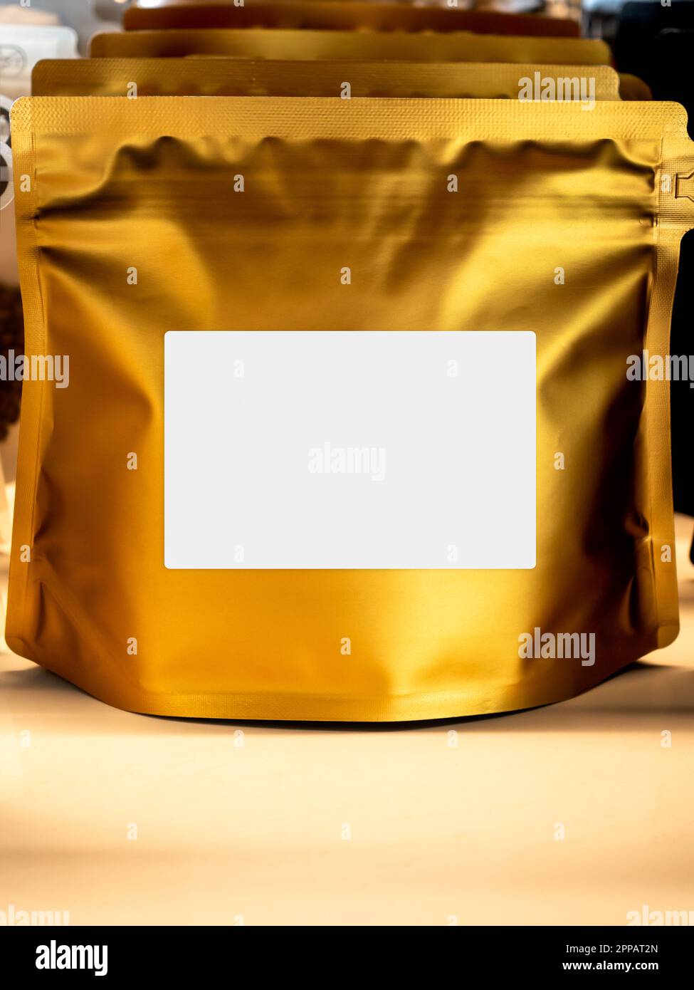 Empty blank white label template on modern gold foil bag coffee beans ...