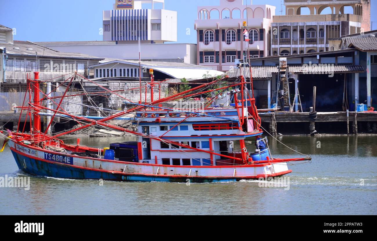 Colourful Thai fishing boats at the harbour on the Rayong River, Rayong Province, Thailand ...