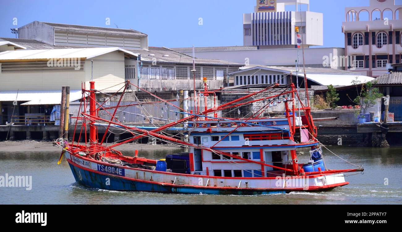Colourful Thai fishing boats at the harbour on the Rayong River, Rayong Province, Thailand ...