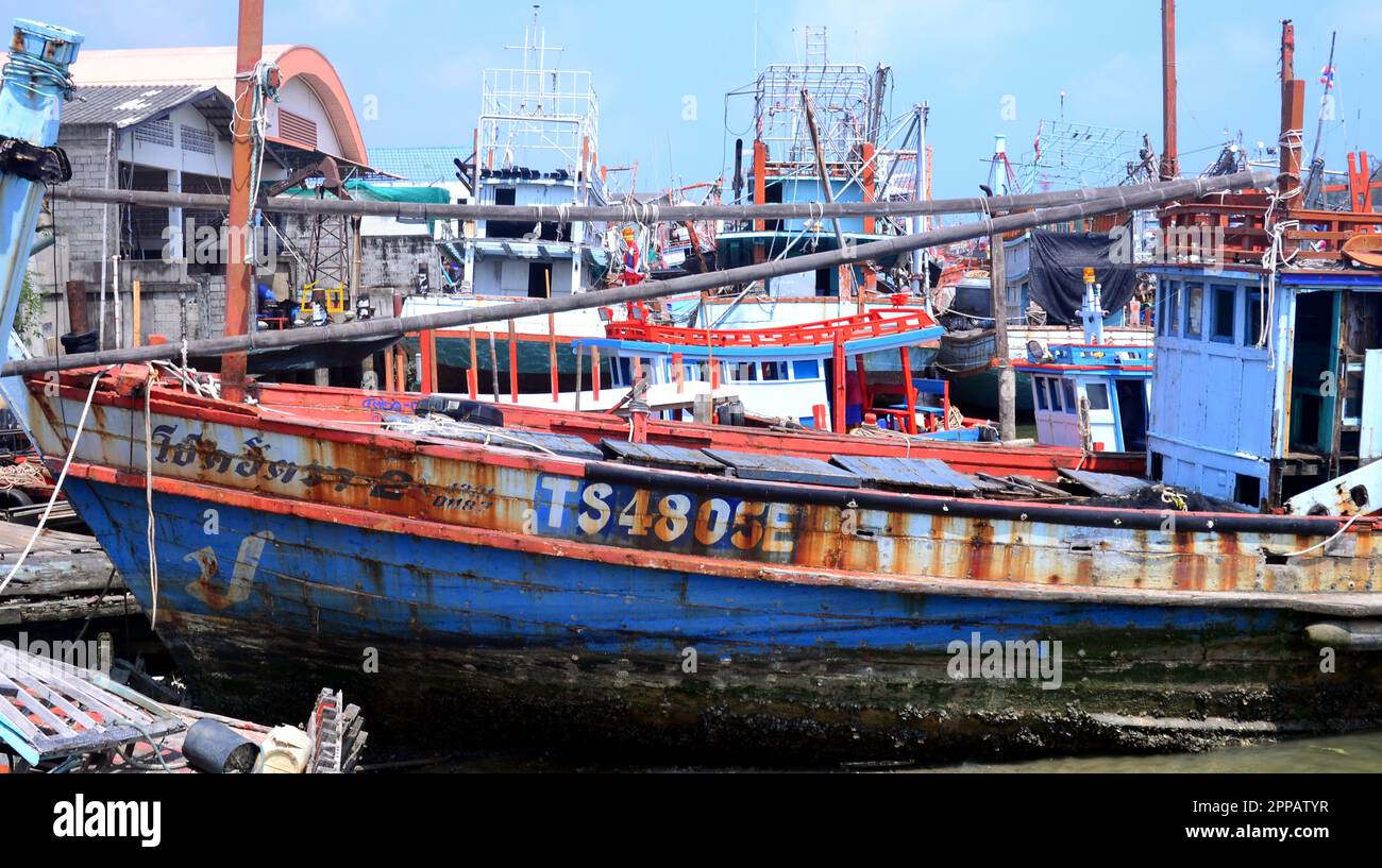 Colourful Thai fishing boats at the harbour on the Rayong River, Rayong Province, Thailand ...