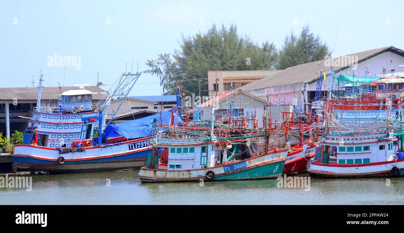 Colourful Thai fishing boats at the harbour on the Rayong River, Rayong Province, Thailand ...