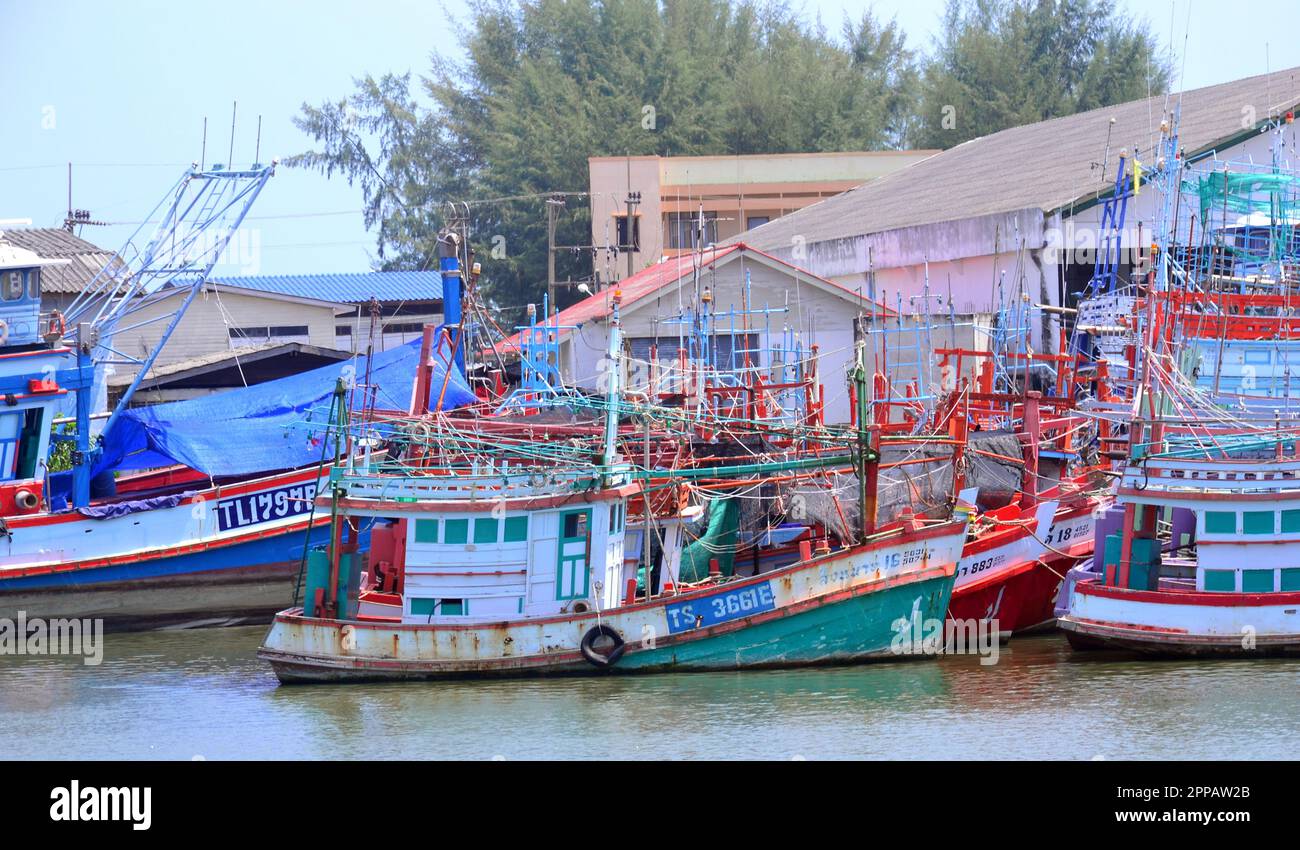 Colourful Thai fishing boats at the harbour on the Rayong River, Rayong Province, Thailand ...