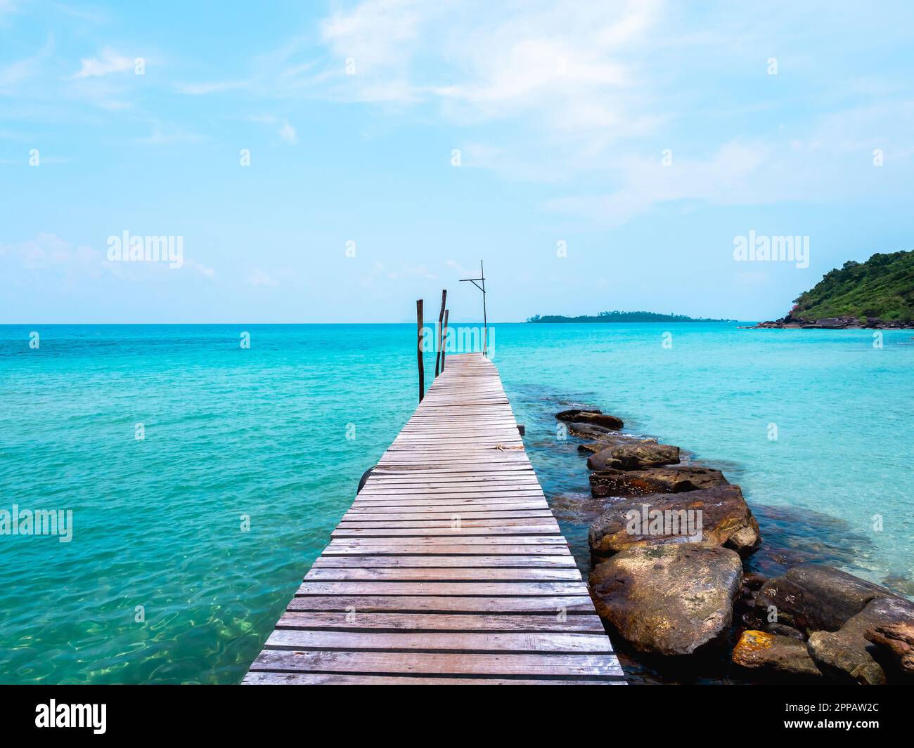Wooden bridge heading to the blue sea. Brown wood plank pathway bridge ...