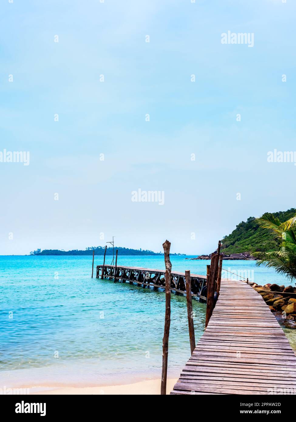 Wooden bridge heading to the blue sea. Brown wood plank pathway bridge ...