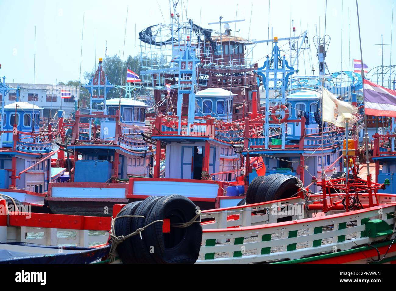 Colourful Thai fishing boats at the harbour on the Rayong River, Rayong Province, Thailand ...