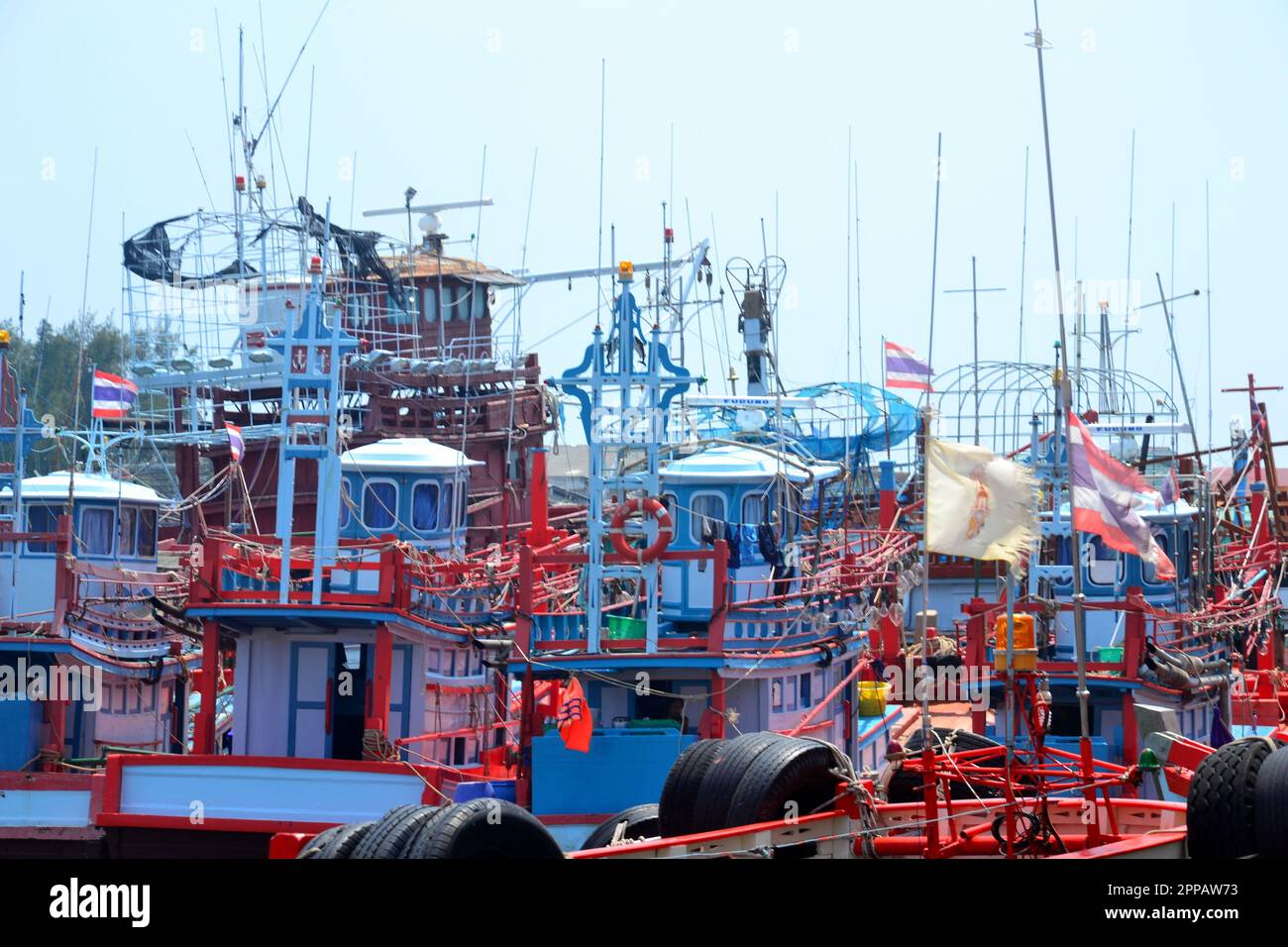 Colourful Thai fishing boats at the harbour on the Rayong River, Rayong Province, Thailand ...