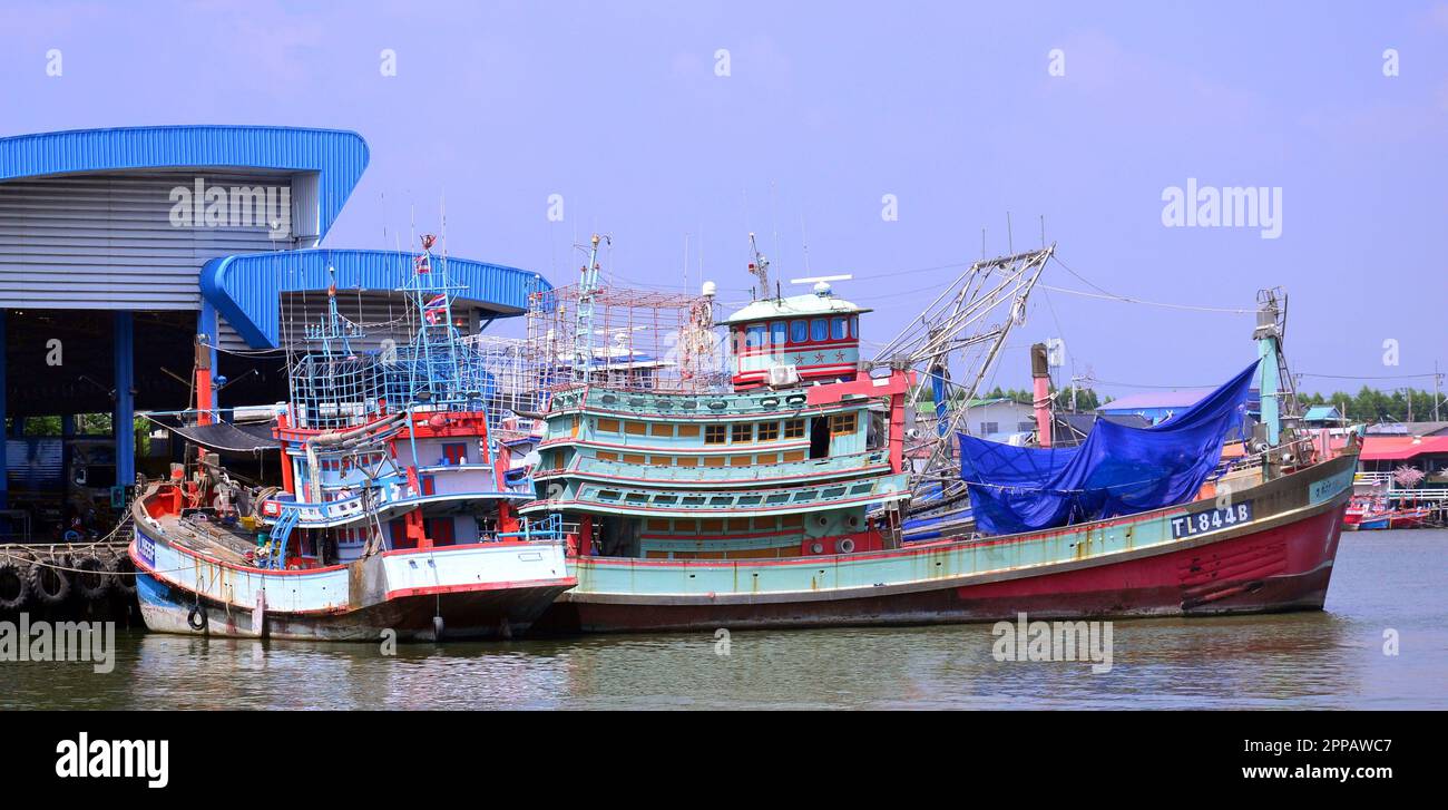 Colourful Thai fishing boats at the harbour on the Rayong River, Rayong Province, Thailand ...