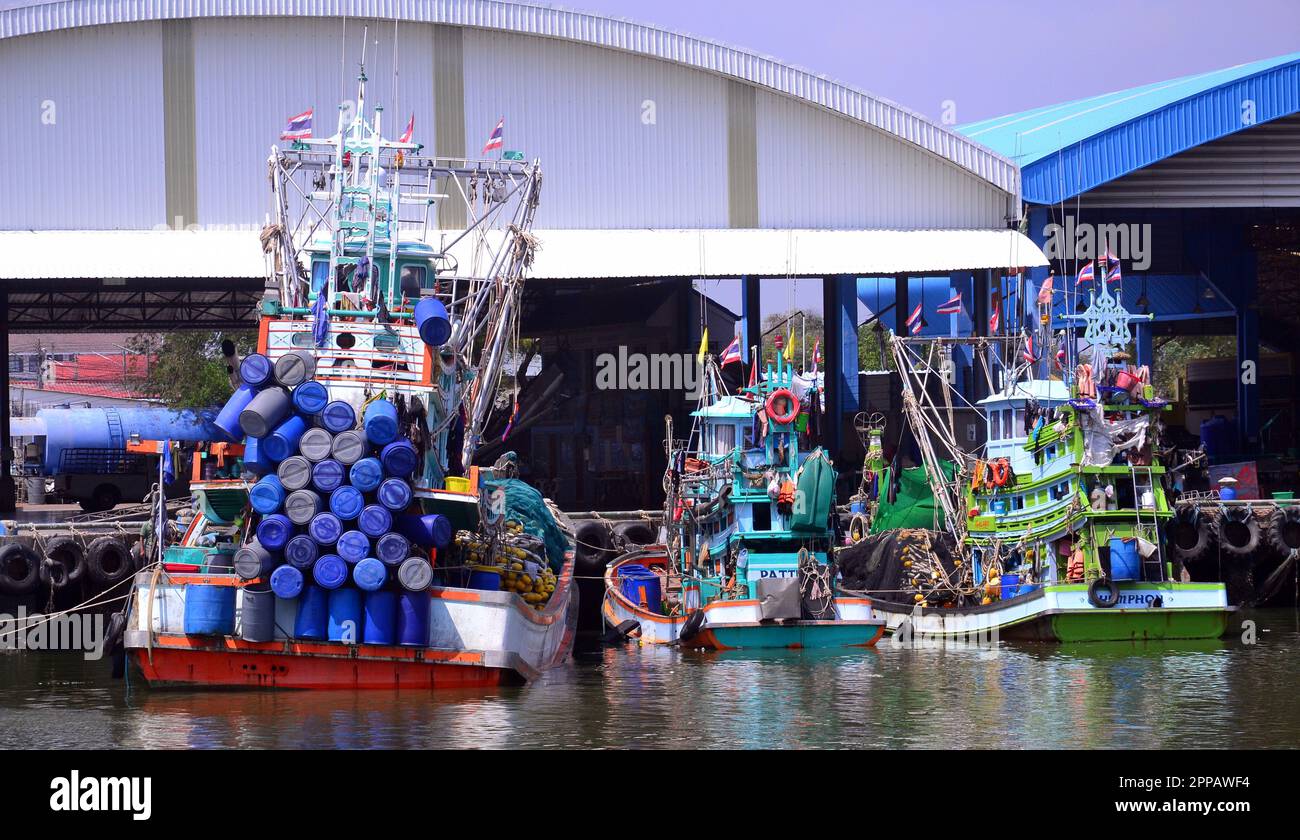 Colourful Thai fishing boats at the harbour on the Rayong River, Rayong Province, Thailand ...