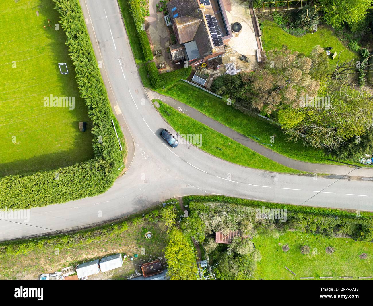 Drone top down view of a dangerous bend and road junction in rural ...