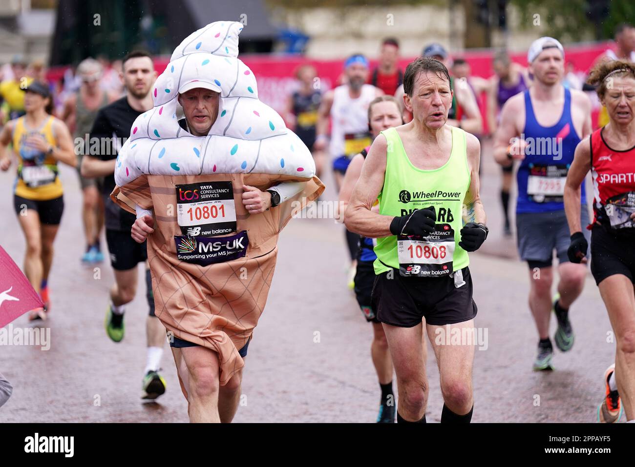 A competitor wearing an Ice Cream fancy dress outfit passes Buckingham ...