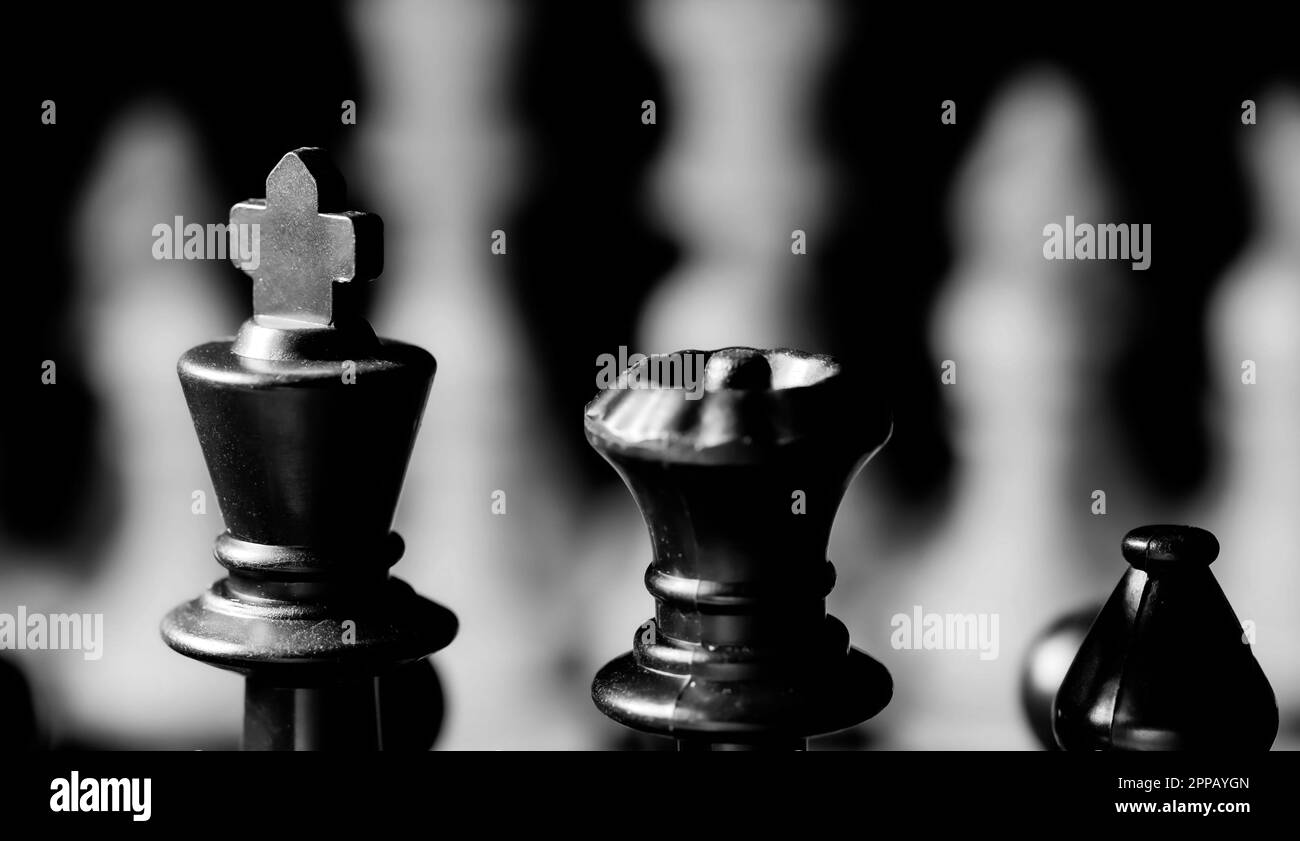 Close up of Chess pieces on a reflective mirror board surface with a ...
