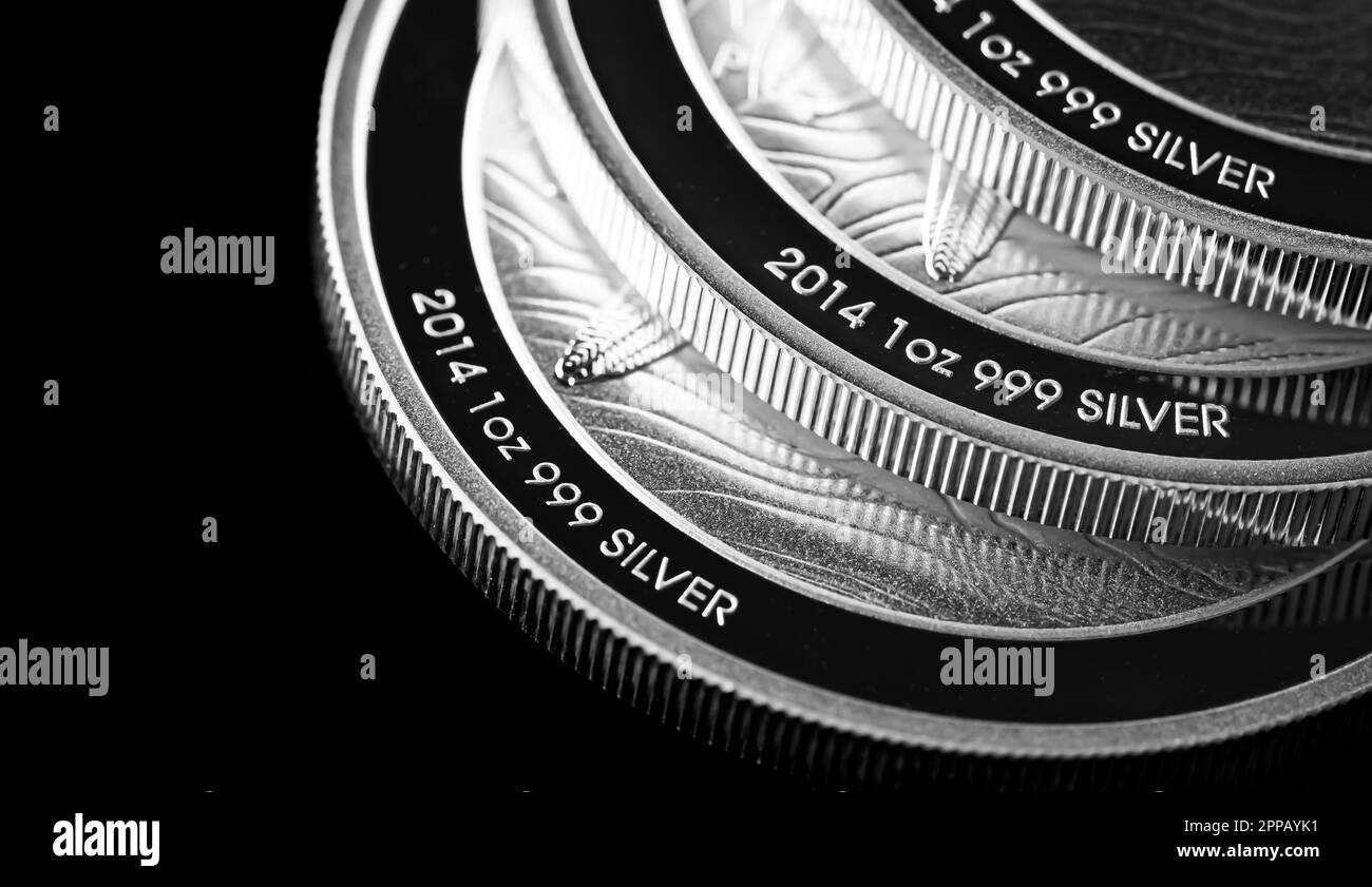 Macro Close up of Silver Bullion Coin on a black mirror background ...