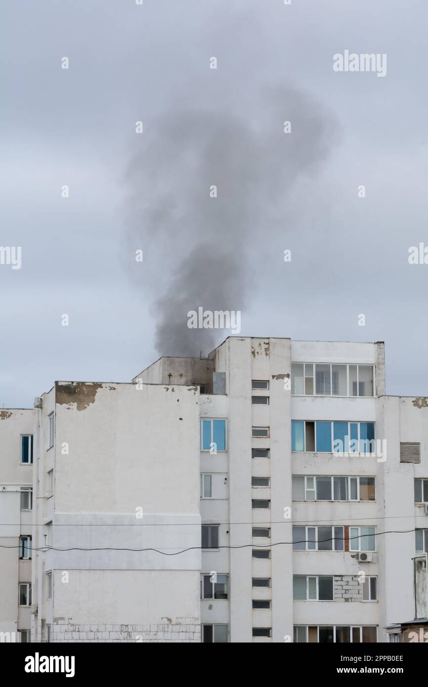 Burning roof of a residential high-rise building, clouds of smoke from ...