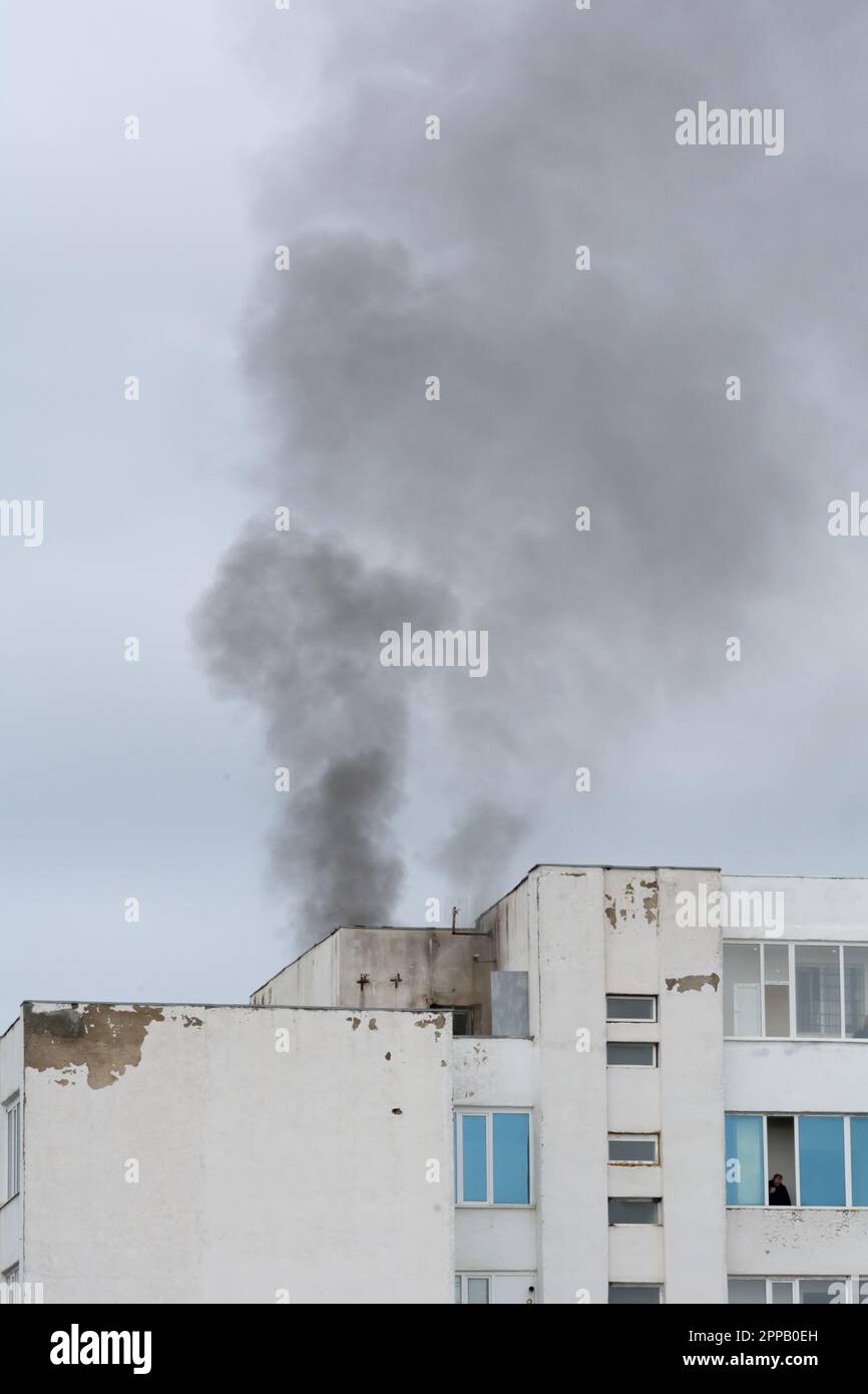 Burning roof of a residential high-rise building, clouds of smoke from ...