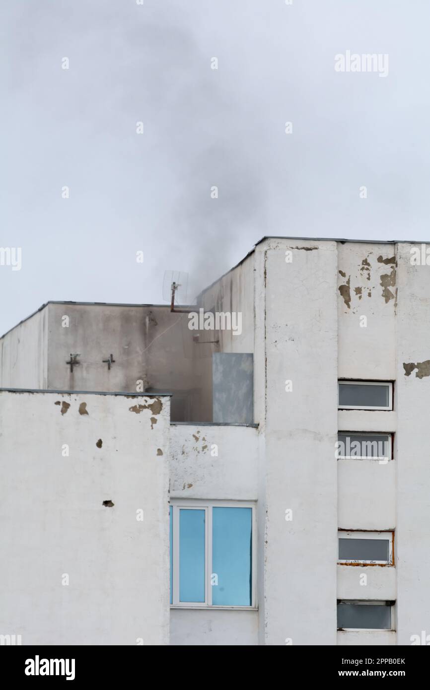Burning roof of a residential high-rise building, clouds of smoke from ...