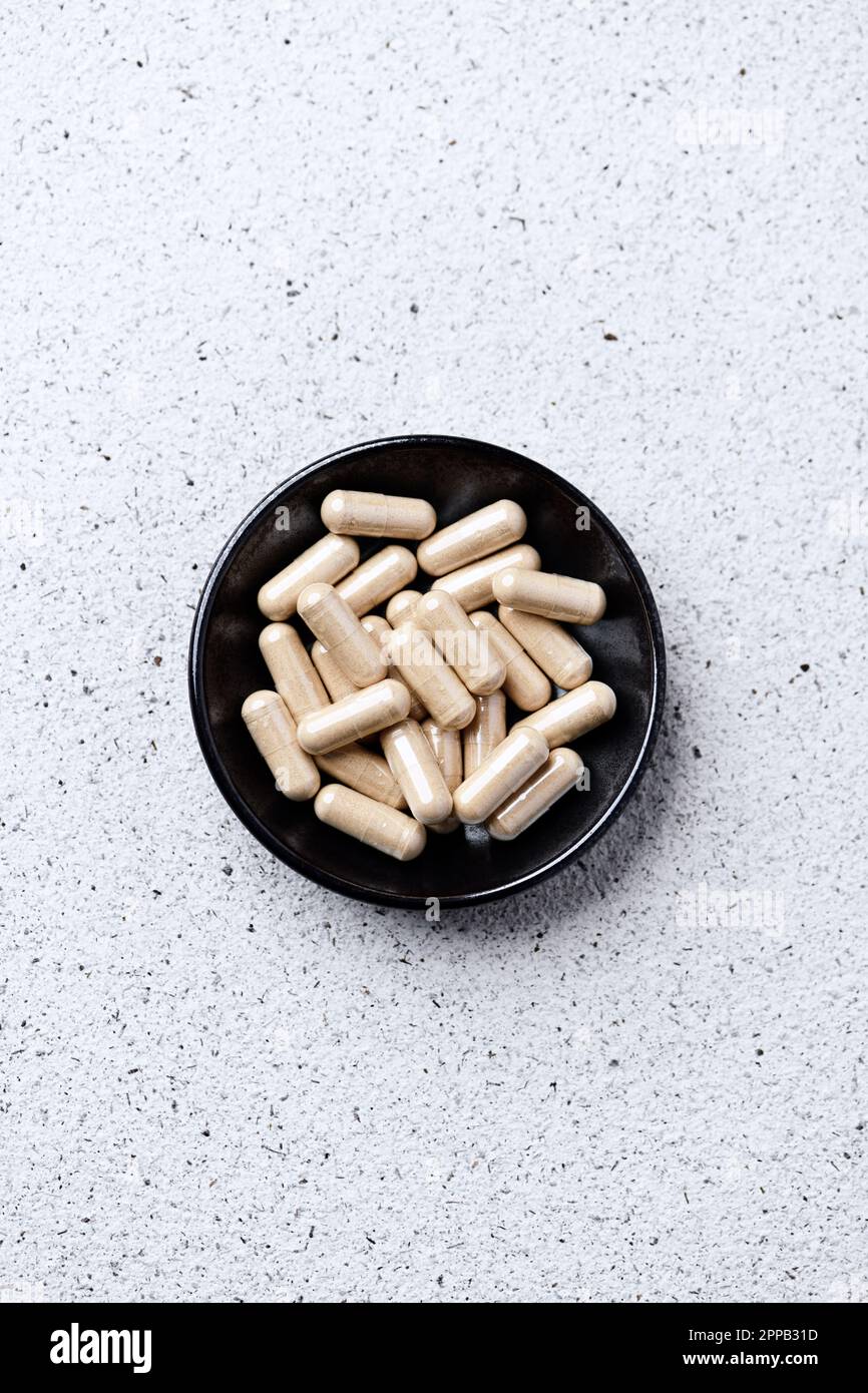 Ashwagandha (Withania somnifera) capsules. Bright paper background ...