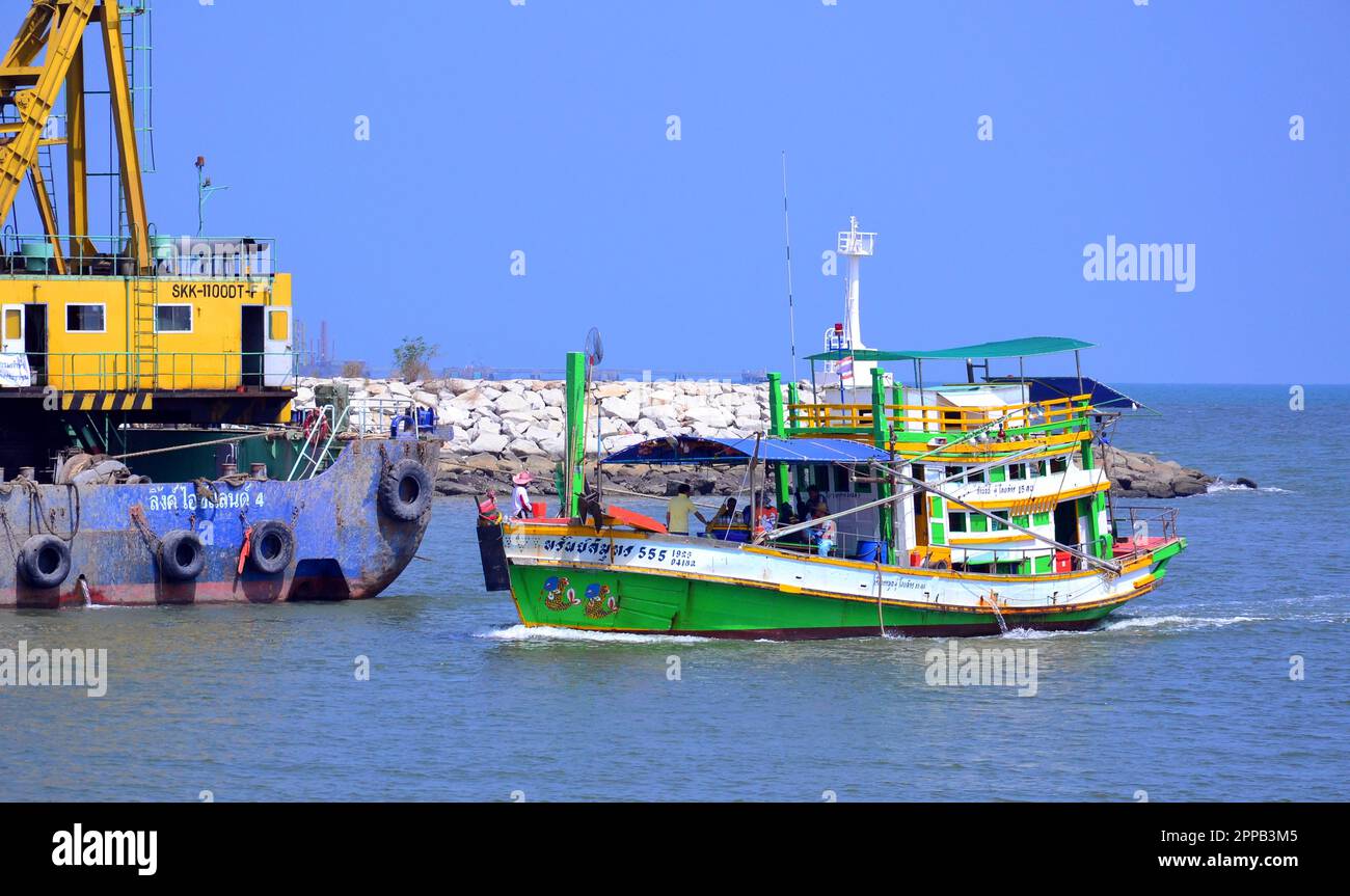 A colourful Thai fishing boat arrives at the harbour on the Rayong River, Rayong Province ...