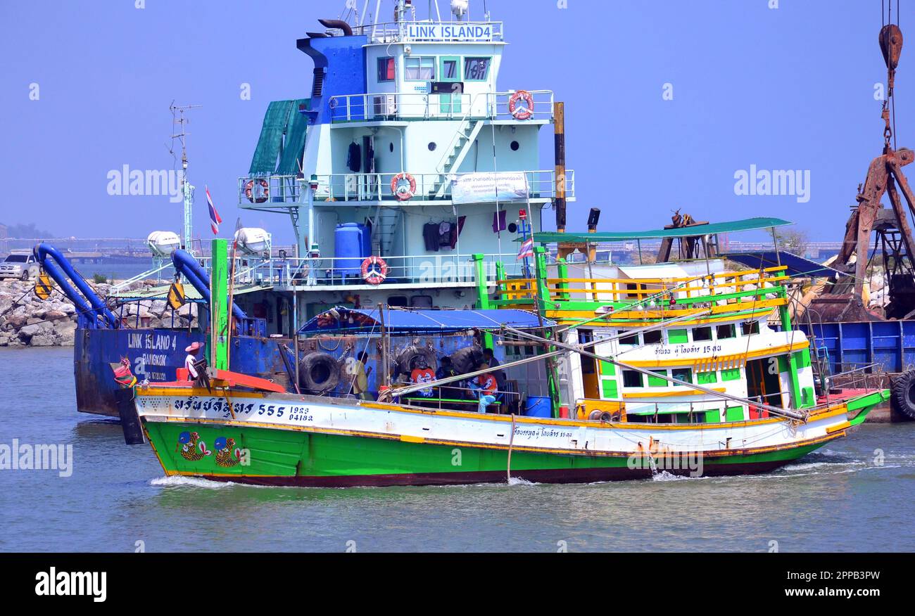 A colourful Thai fishing boat arrives at the harbour on the Rayong River, Rayong Province ...