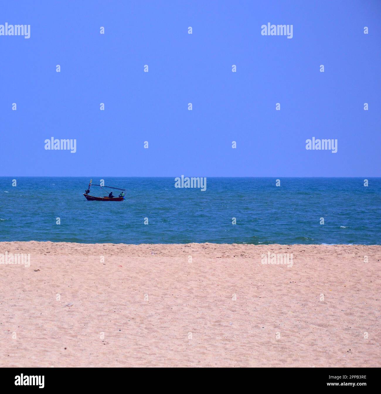 A small boat at sea beyond an empty Laem Charoen Beach, Rayong Province ...