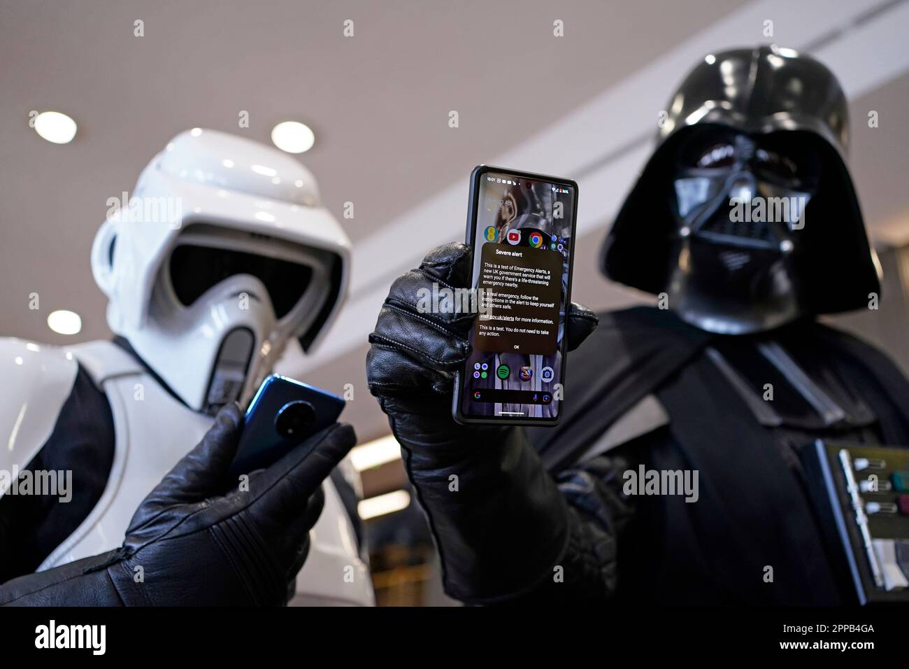 A cosplayer dressed as Darth Vader and a cosplayer dressed as a ...