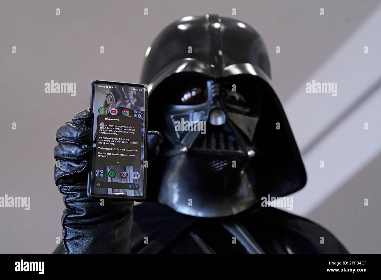A cosplayer dressed as Darth Vader with his mobile phone during a test ...