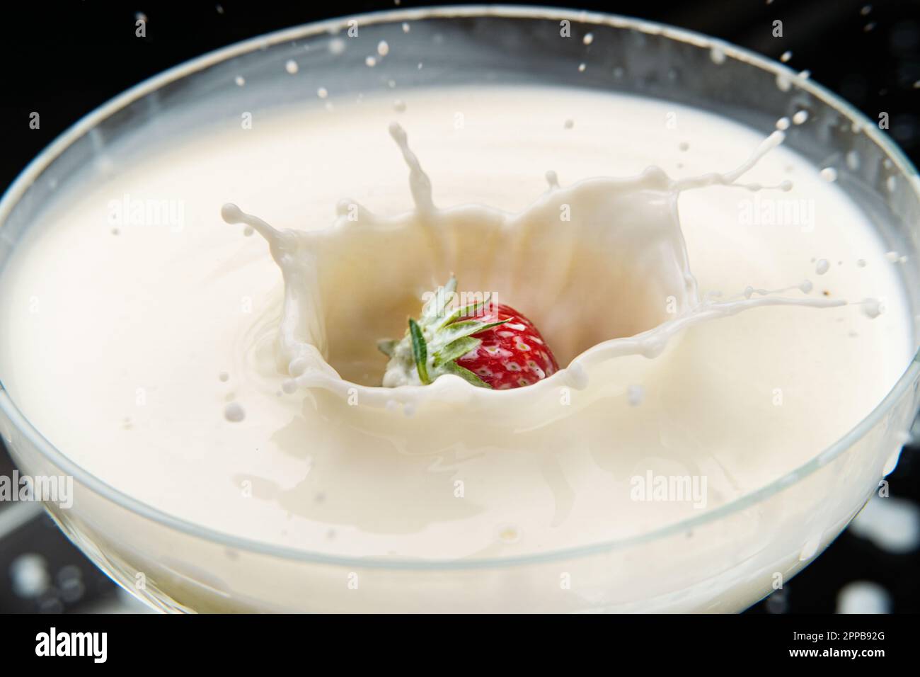 Strawberry falling into splashing milk. Isolated on white Stock Photo ...