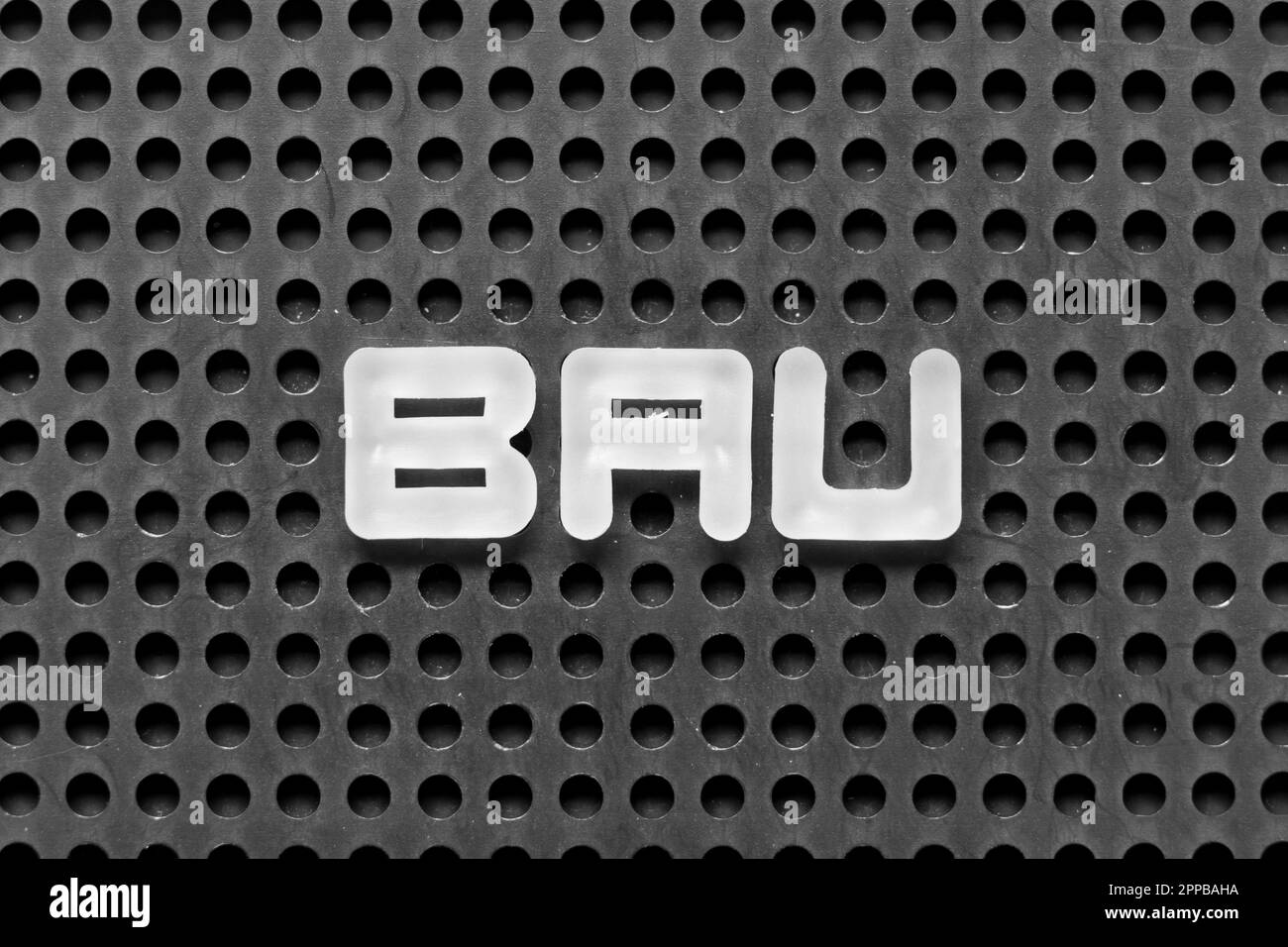 White alphabet letter in word BAU (abbreviation of business as usual ...