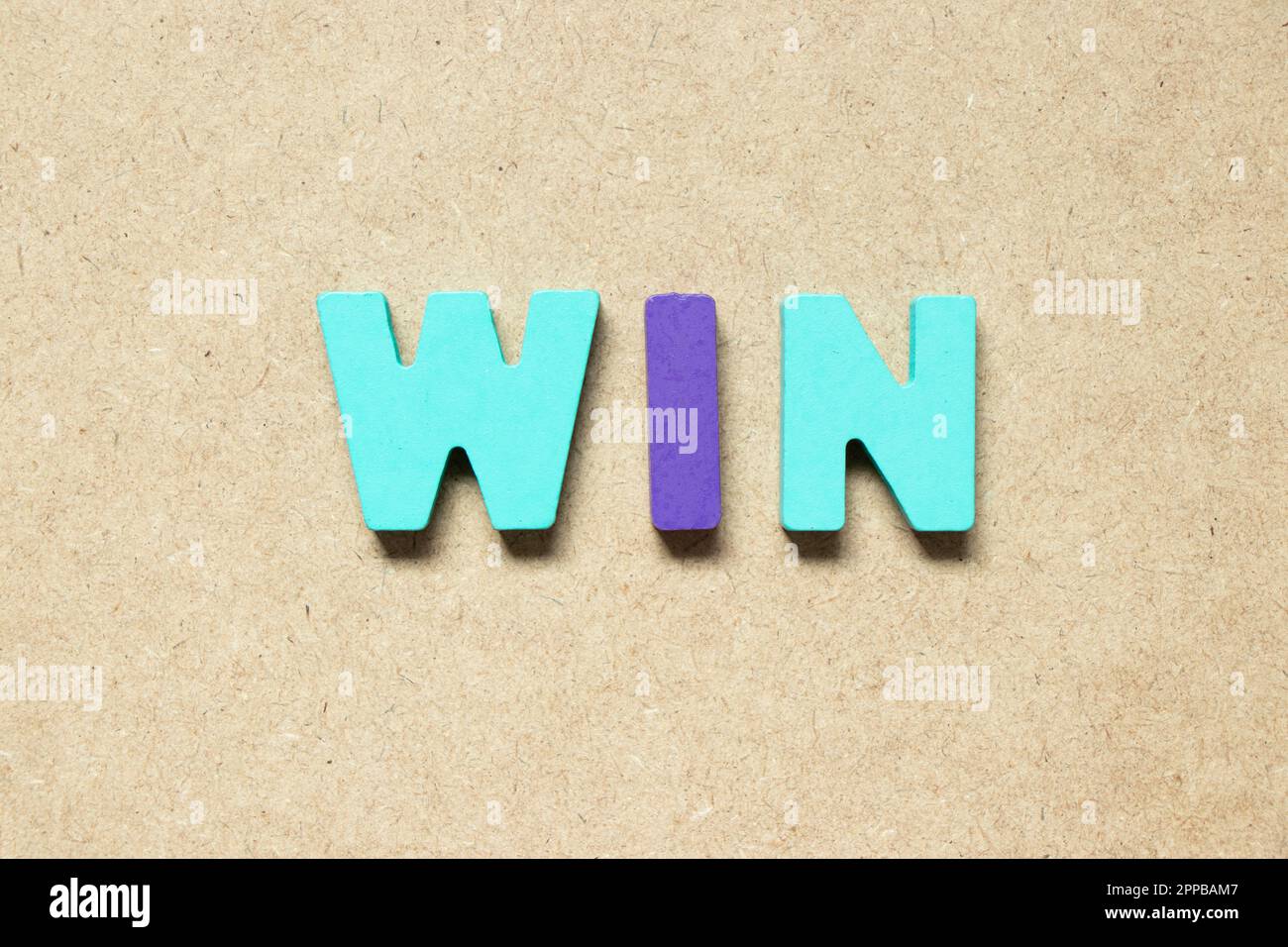 Color alphabet letter in word win on wood background Stock Photo - Alamy