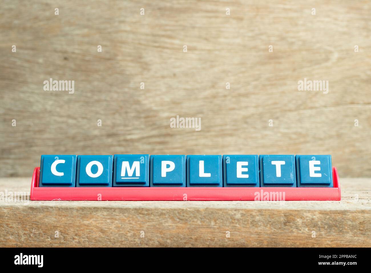 Tile letter on red rack in word complete on wood background Stock Photo ...