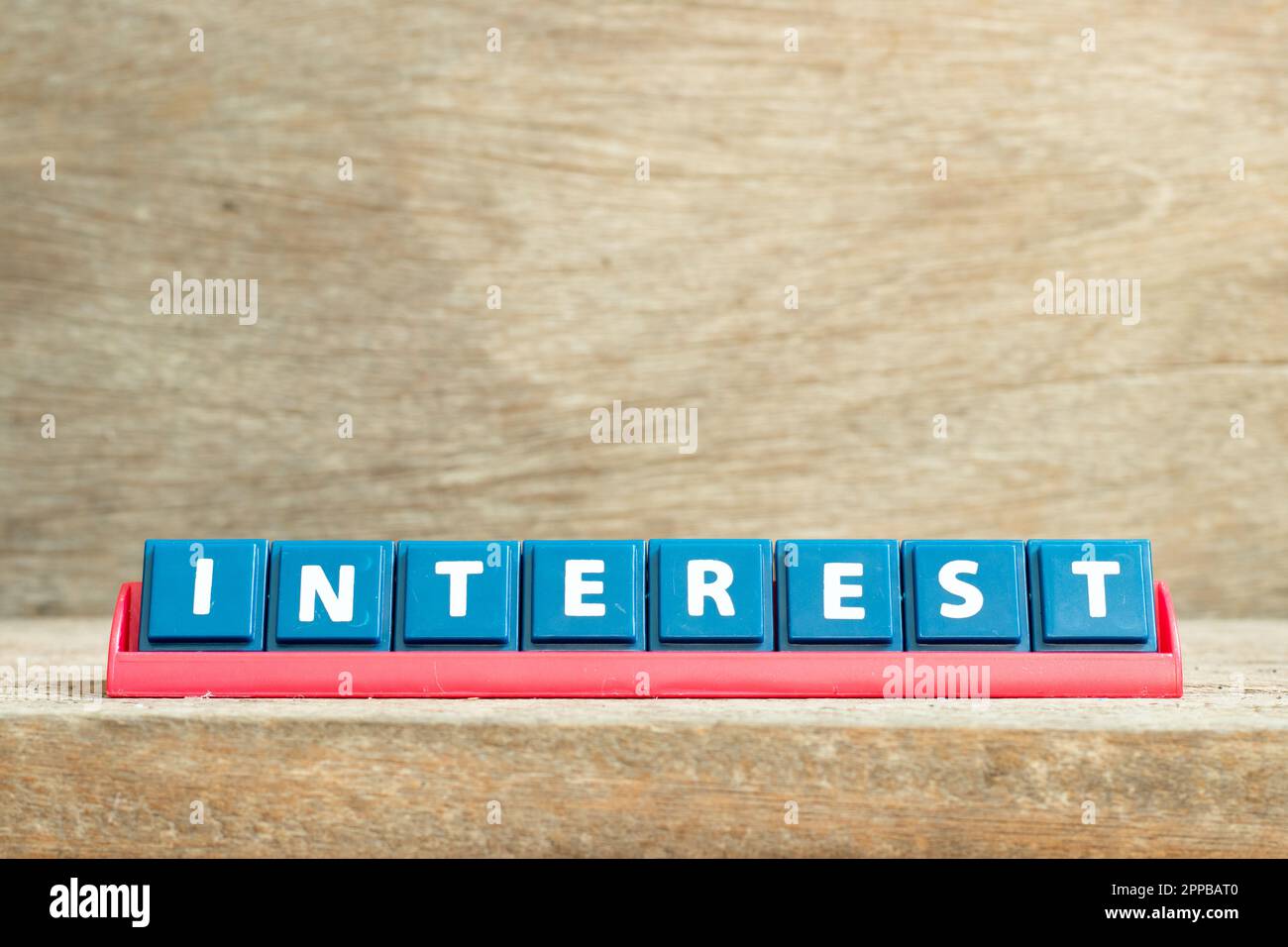 Tile letter on red rack in word interest on wood background Stock Photo ...