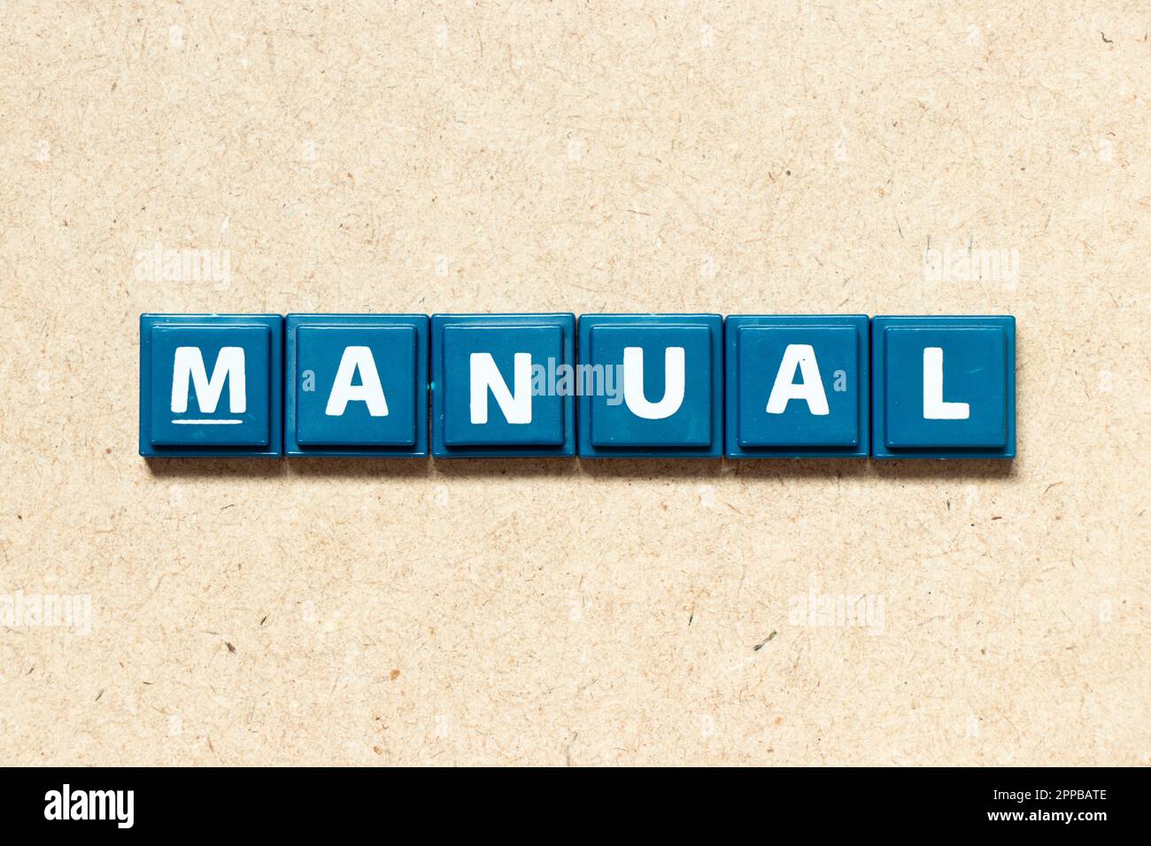 Tile alphabet letter in word manual on wood background Stock Photo - Alamy