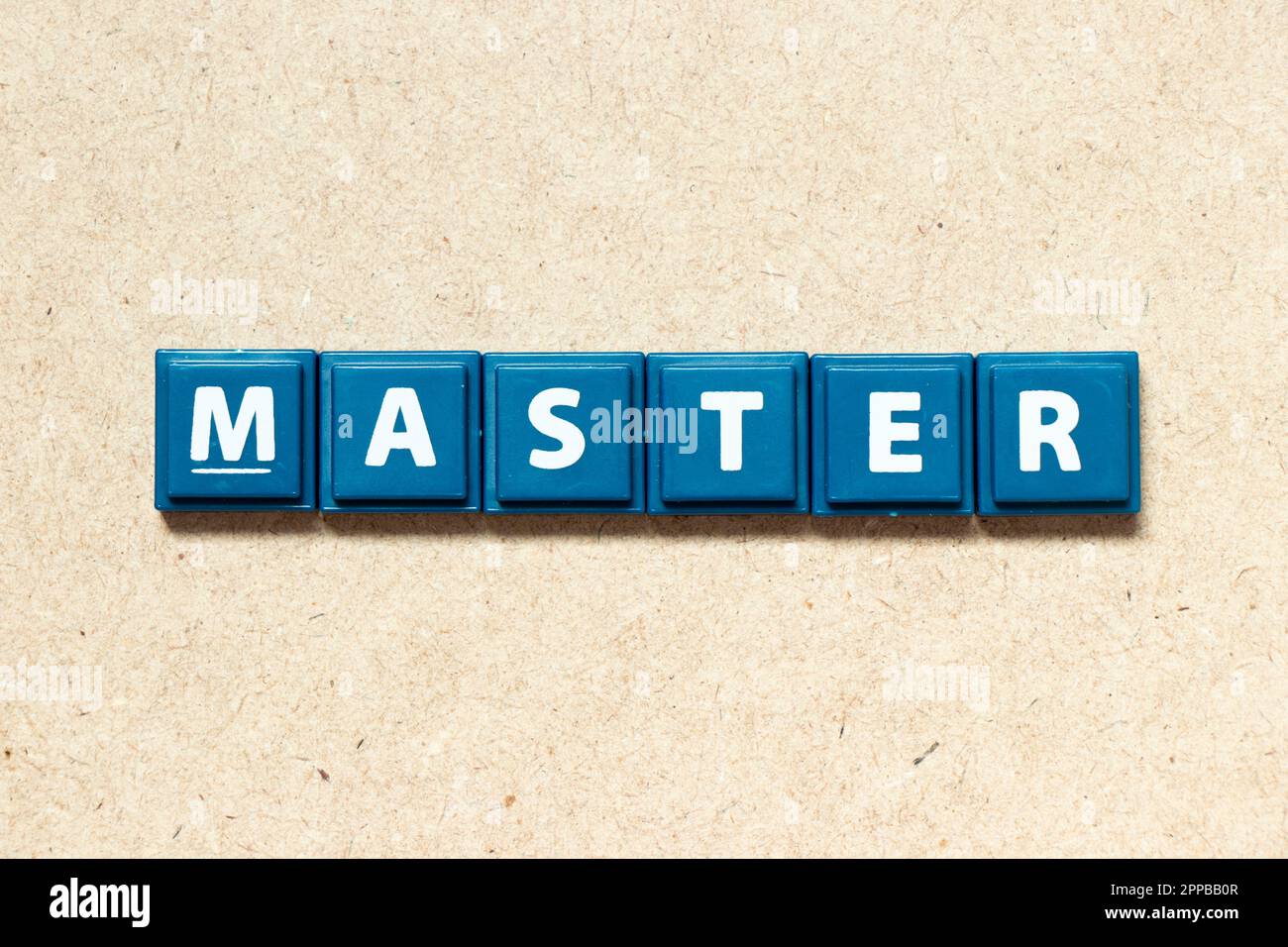 Tile alphabet letter in word master on wood background Stock Photo - Alamy