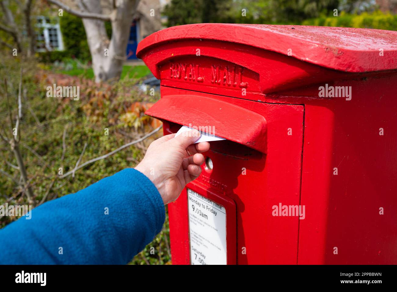 Person seen posting a letter in an old style, red-painted Royal Mail ... Person seen posting a letter in an old style, red-painted Royal Mail ...