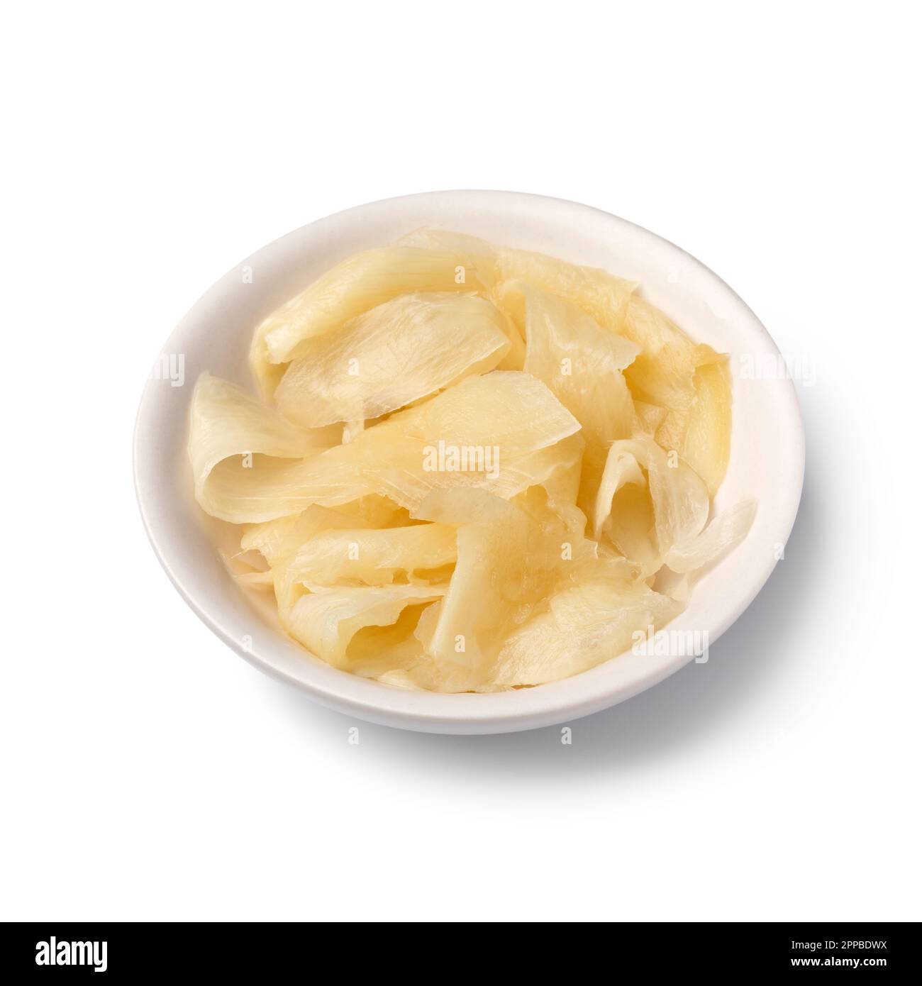 White bowl with pickled white Japanese sushi ginger close up isolated ...