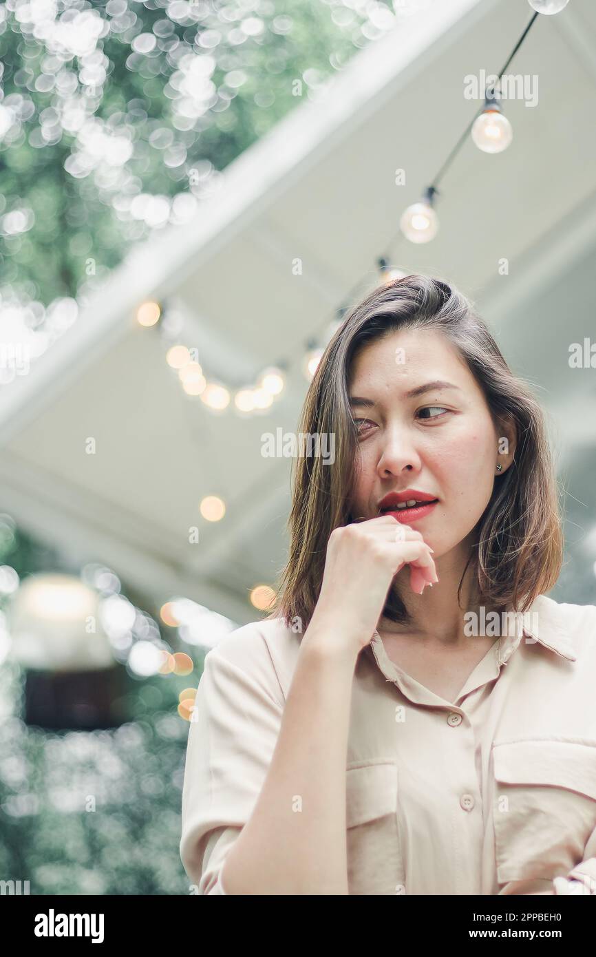 Women standing under the lights hanging to decorate the place Stock ...