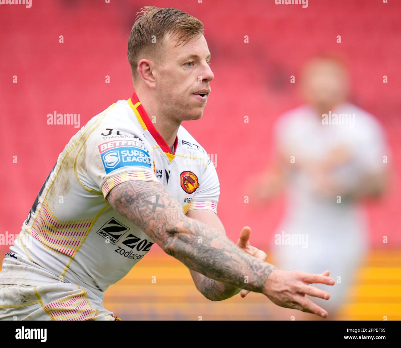 Tom Johnstone #24 of Catalans Dragons passes the ball during the ...