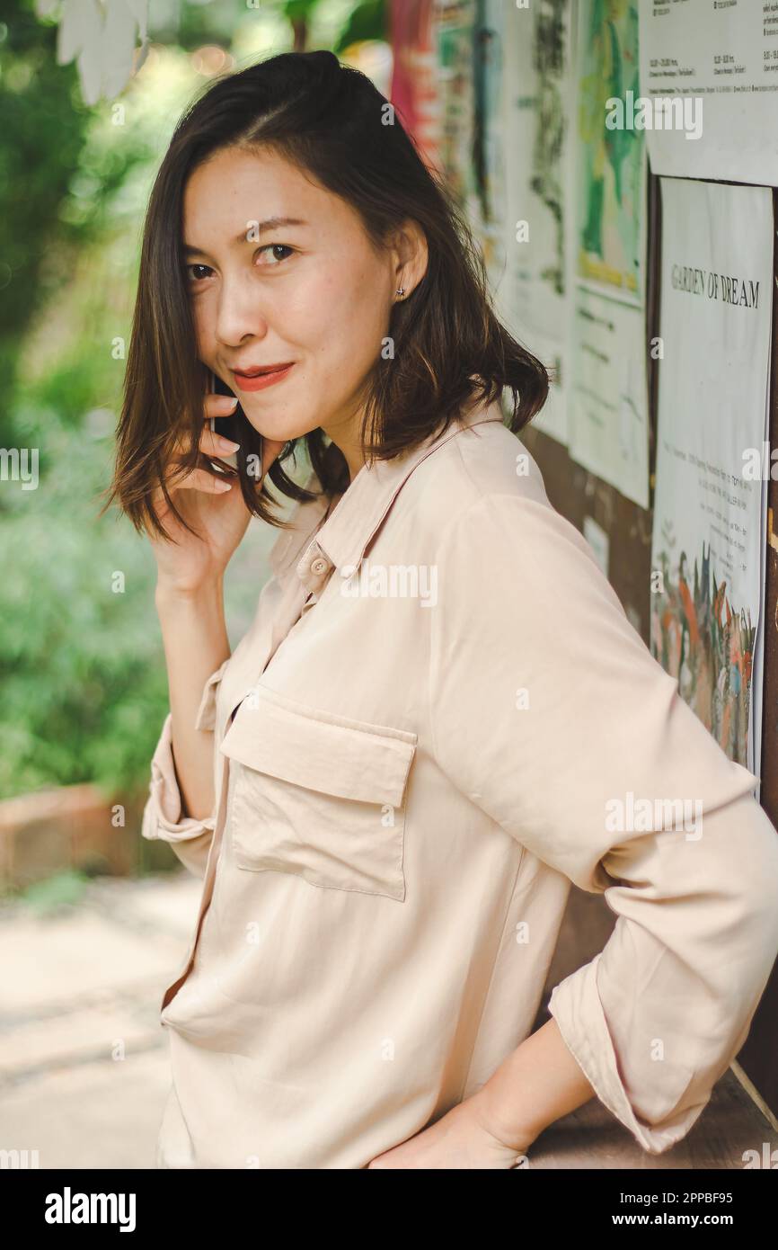 Women leaning against wall on hi-res stock photography and images - Alamy