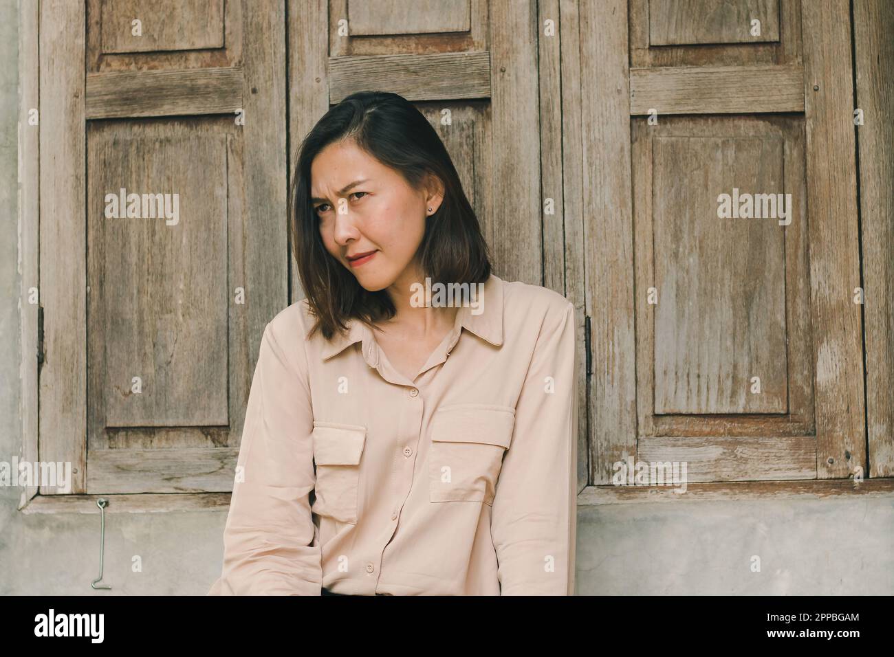 Women are sitting against the wooden window Stock Photo - Alamy